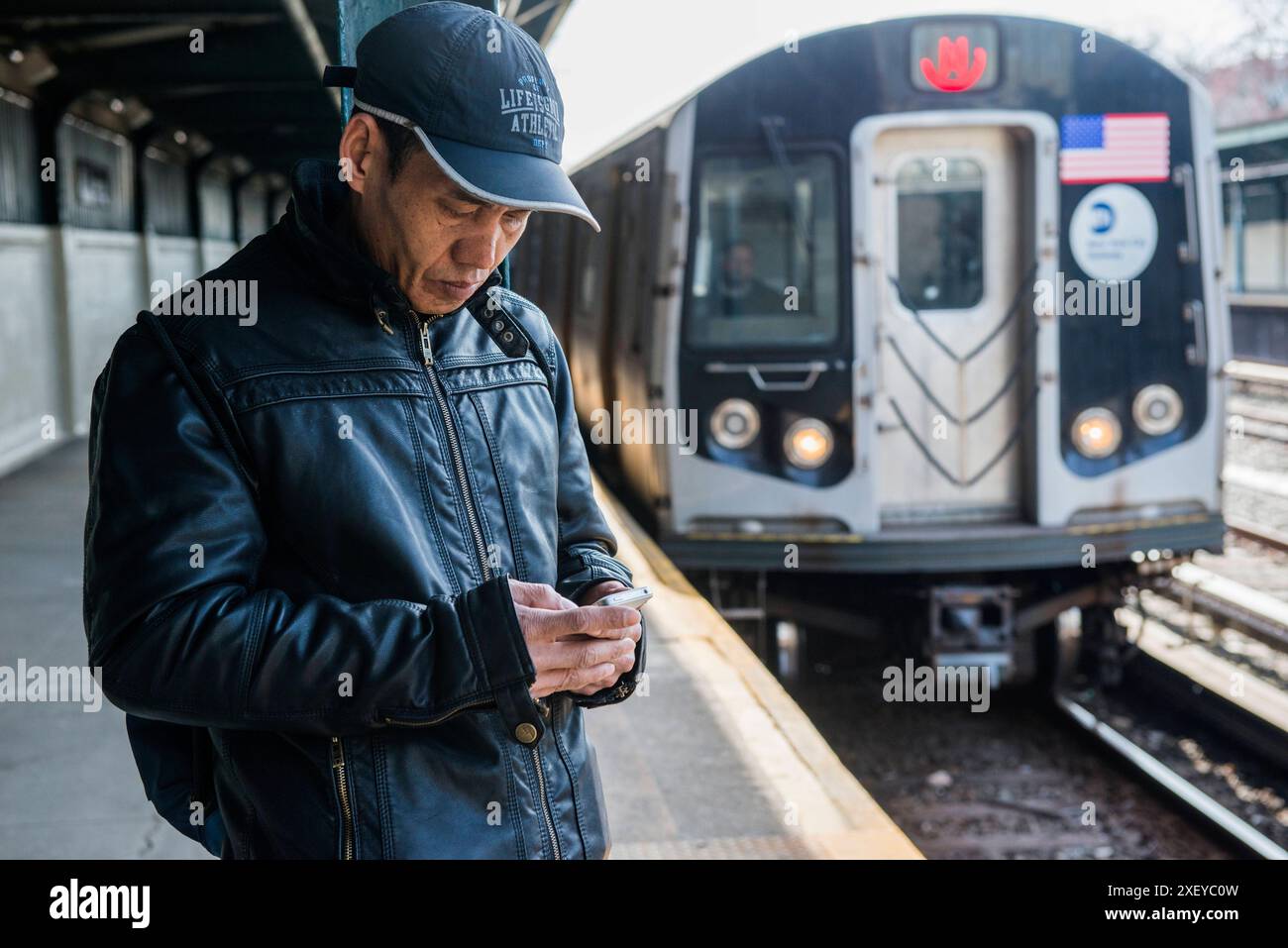 Chinese Man & Subway Train A Chinese Man waiting on a Subway Station s ...