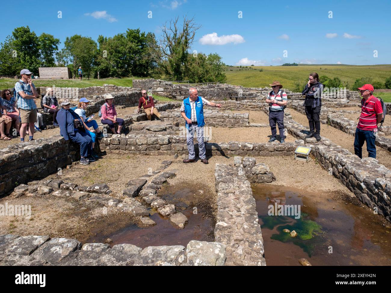 Vindolanda tour guide taking visitors around the Vindolanda Roman Fort ...
