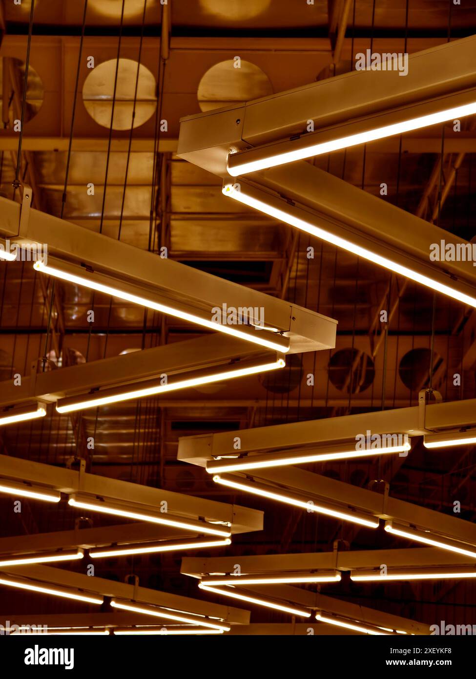 Ceiling with pipes is beautifully decorated with many industrial lamps ...