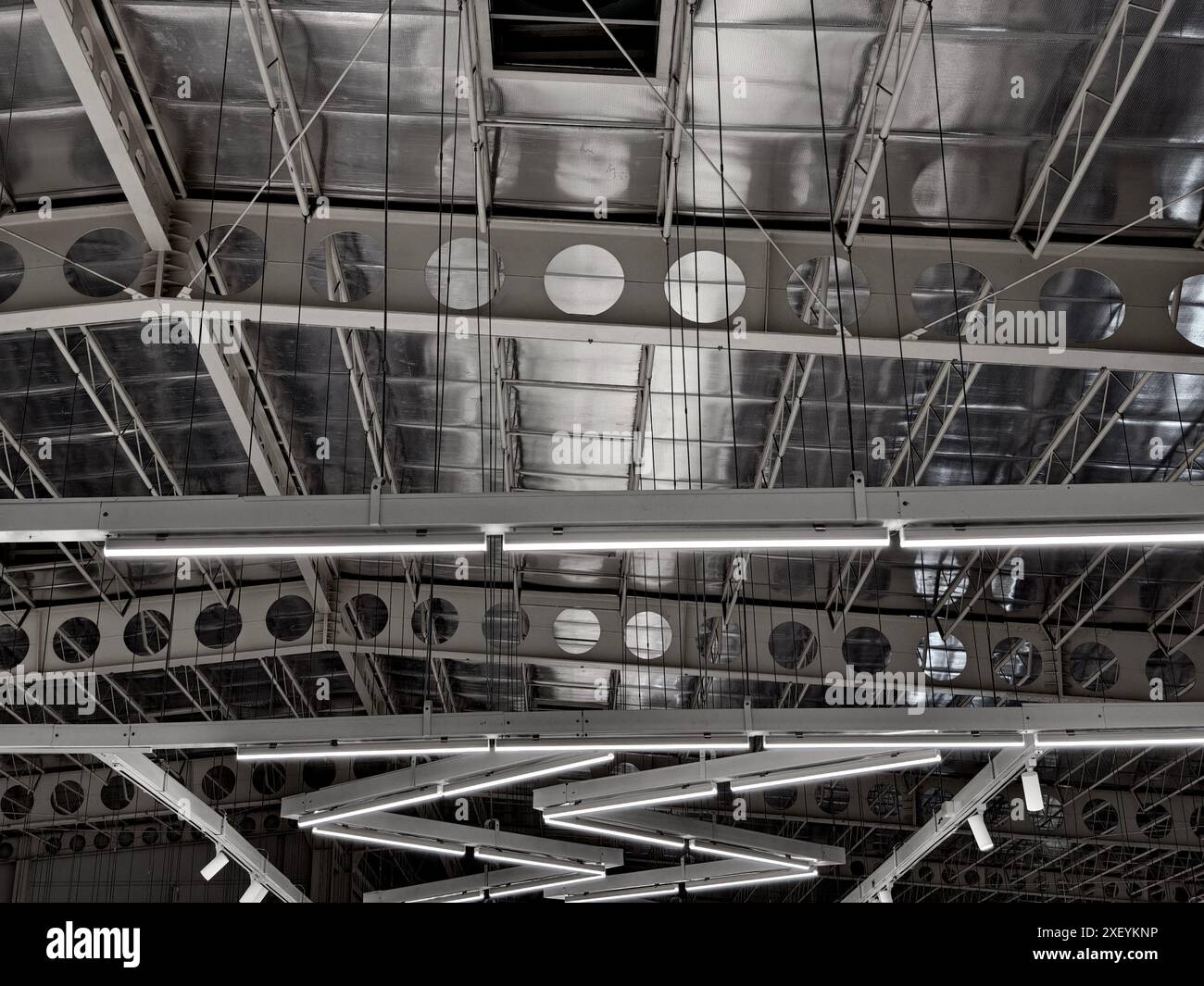 Ceiling with pipes is beautifully decorated with many industrial lamps ...