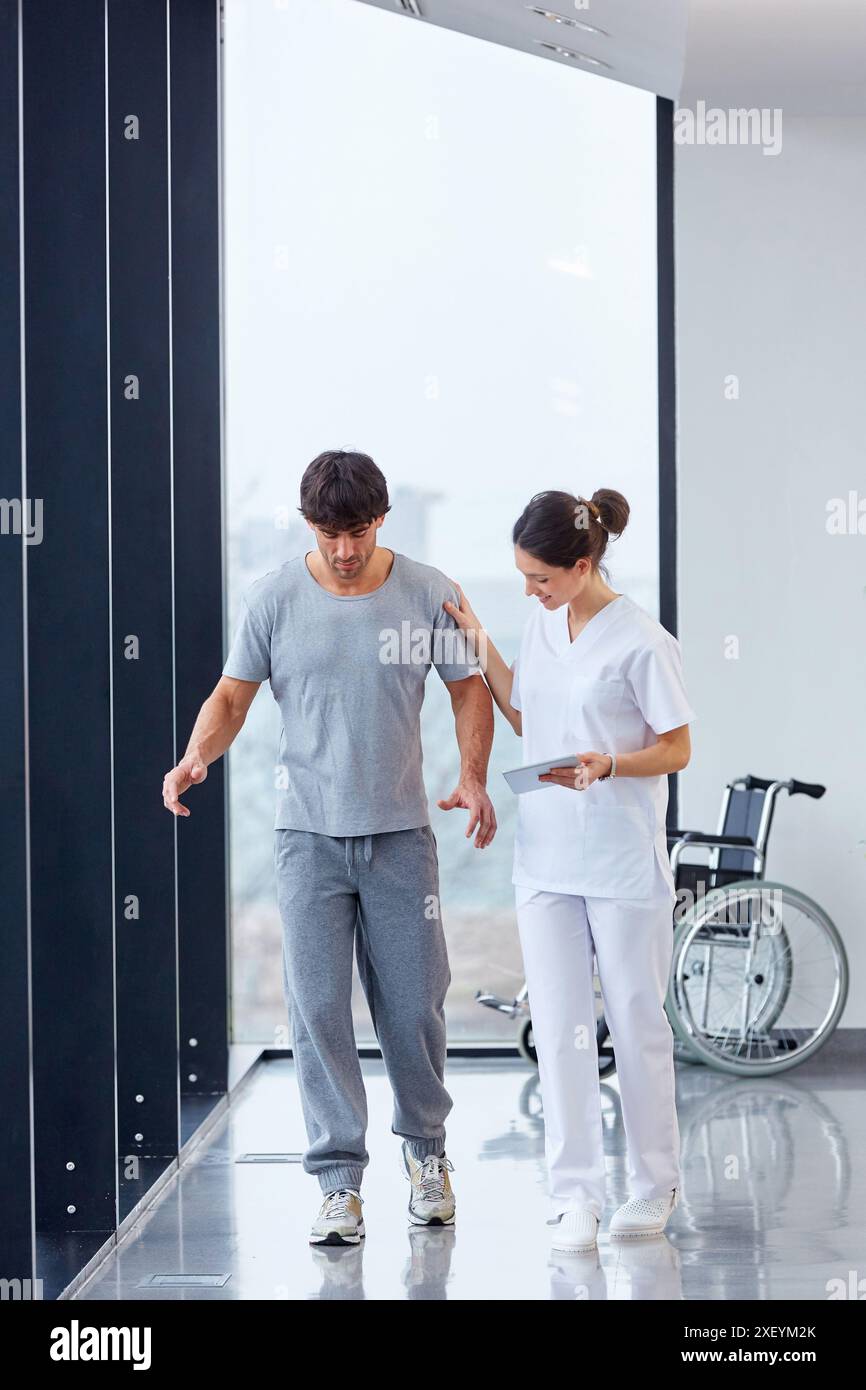 Physical therapist helping a patient to walk Stock Photo - Alamy