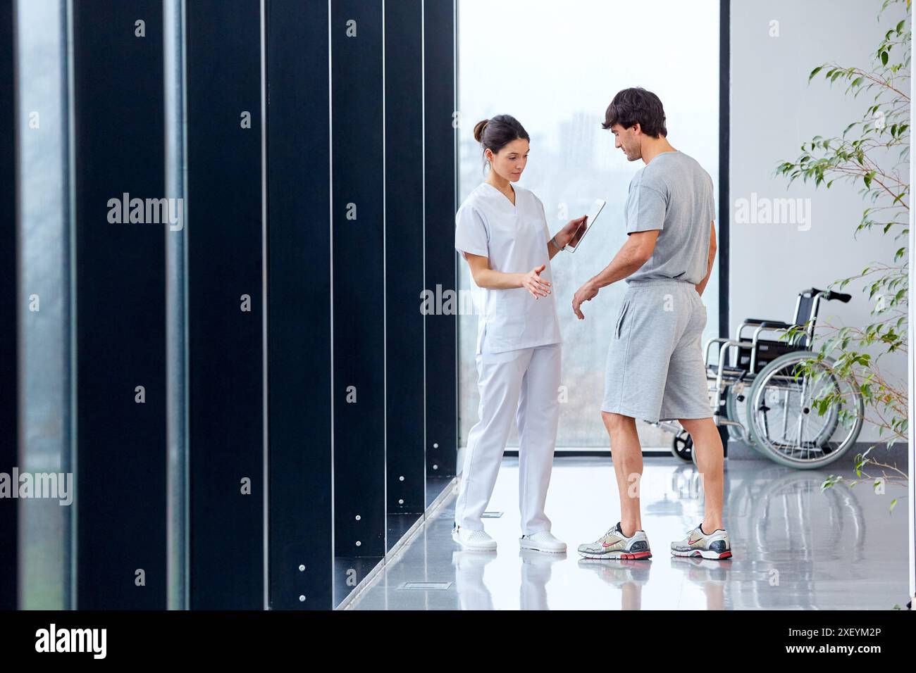 Physical therapist helping a patient to walk Stock Photo - Alamy