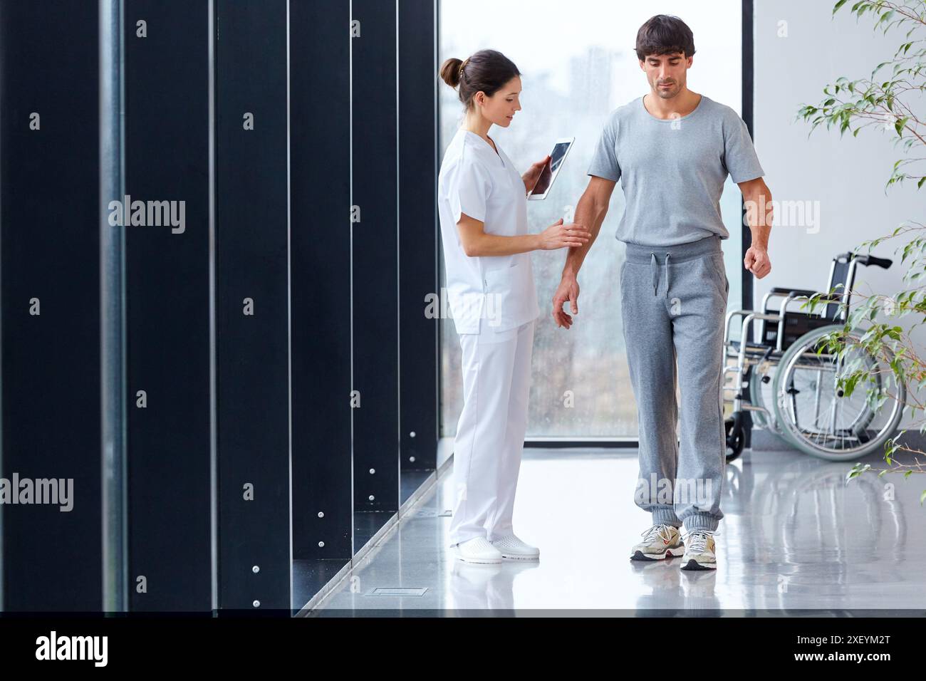 Physical therapist helping a patient to walk Stock Photo - Alamy