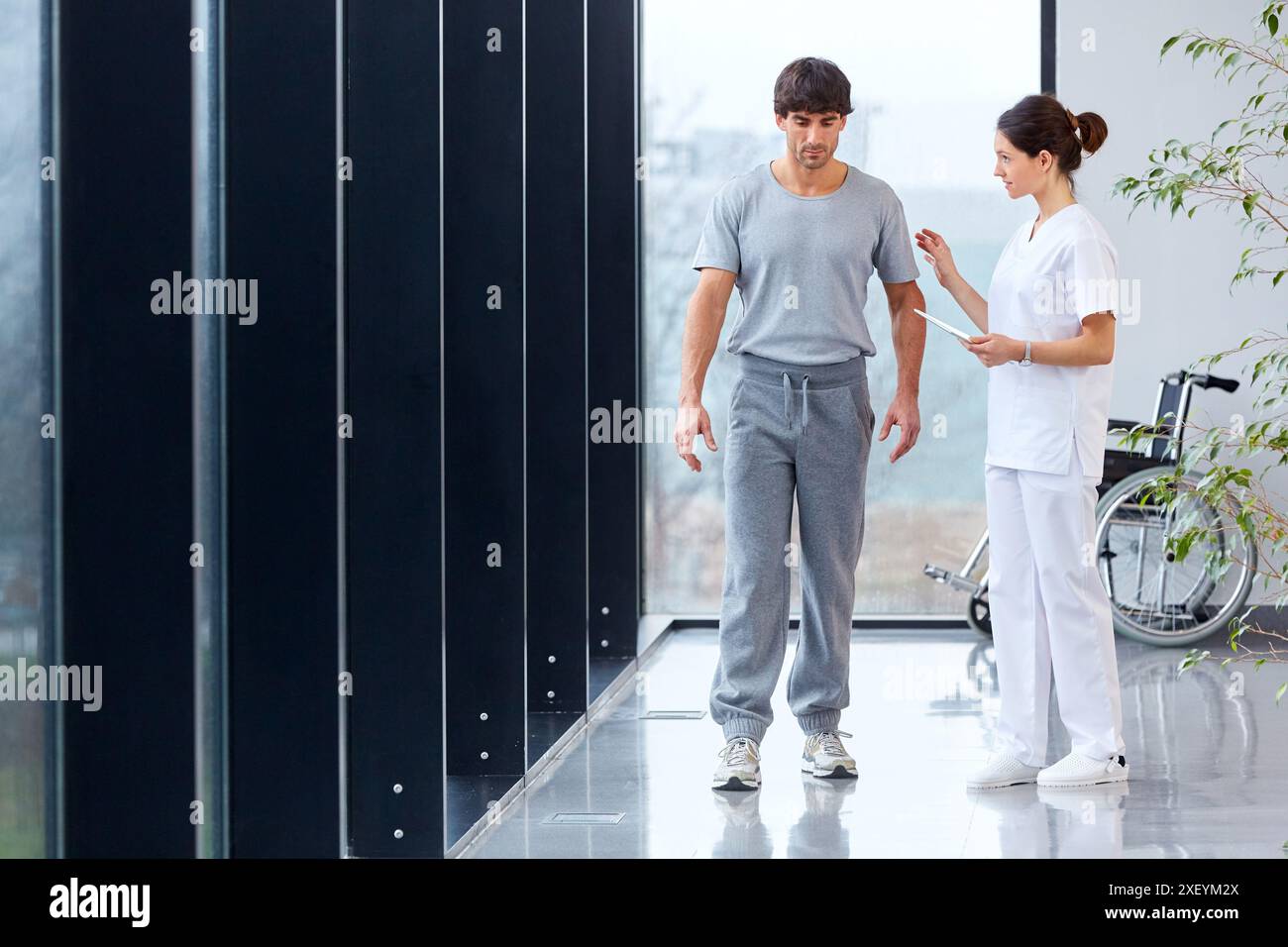 Physical therapist helping a patient to walk Stock Photo - Alamy