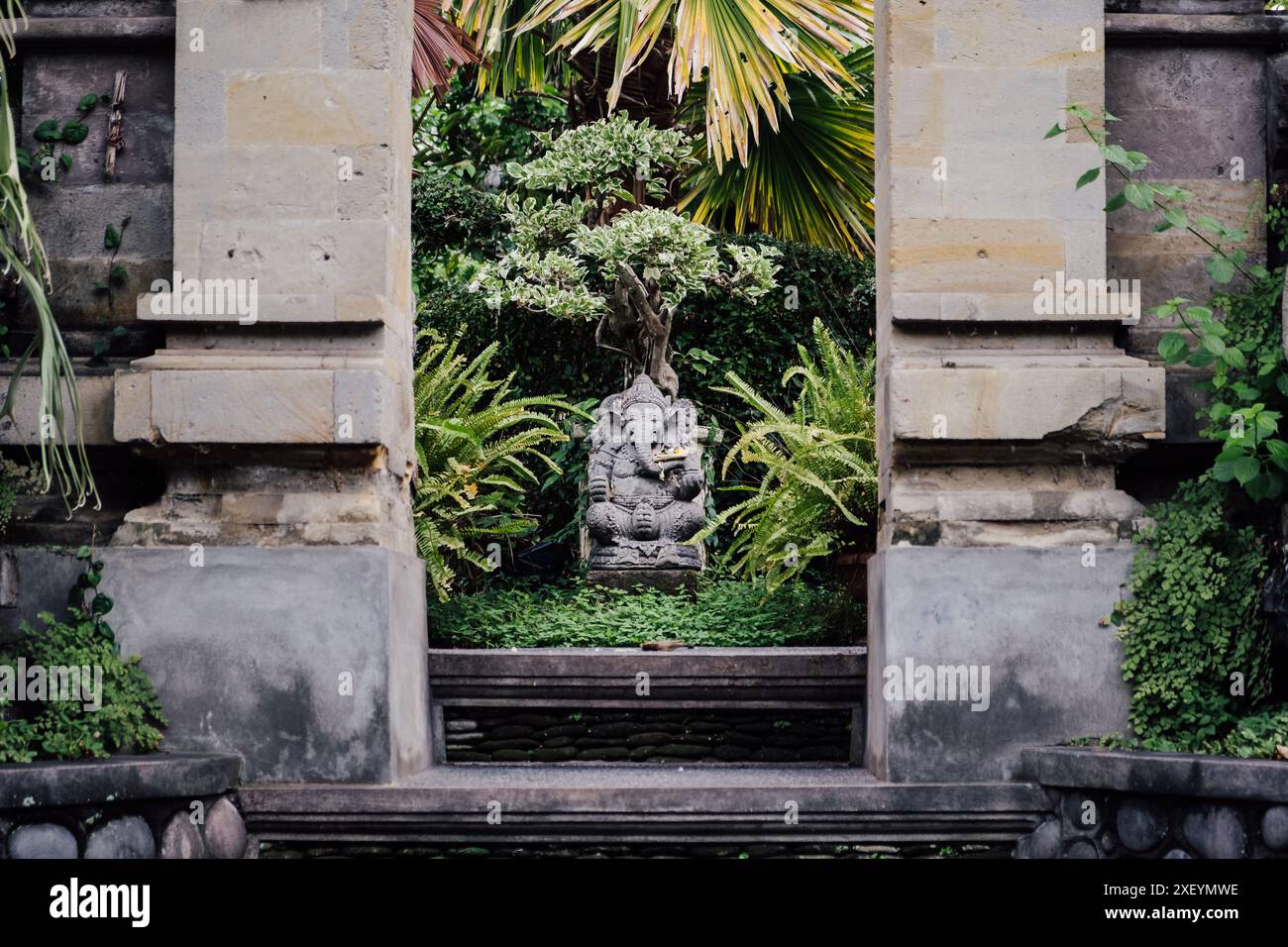 Buddhist elephant statue in a lush garden in Bali Stock Photo - Alamy