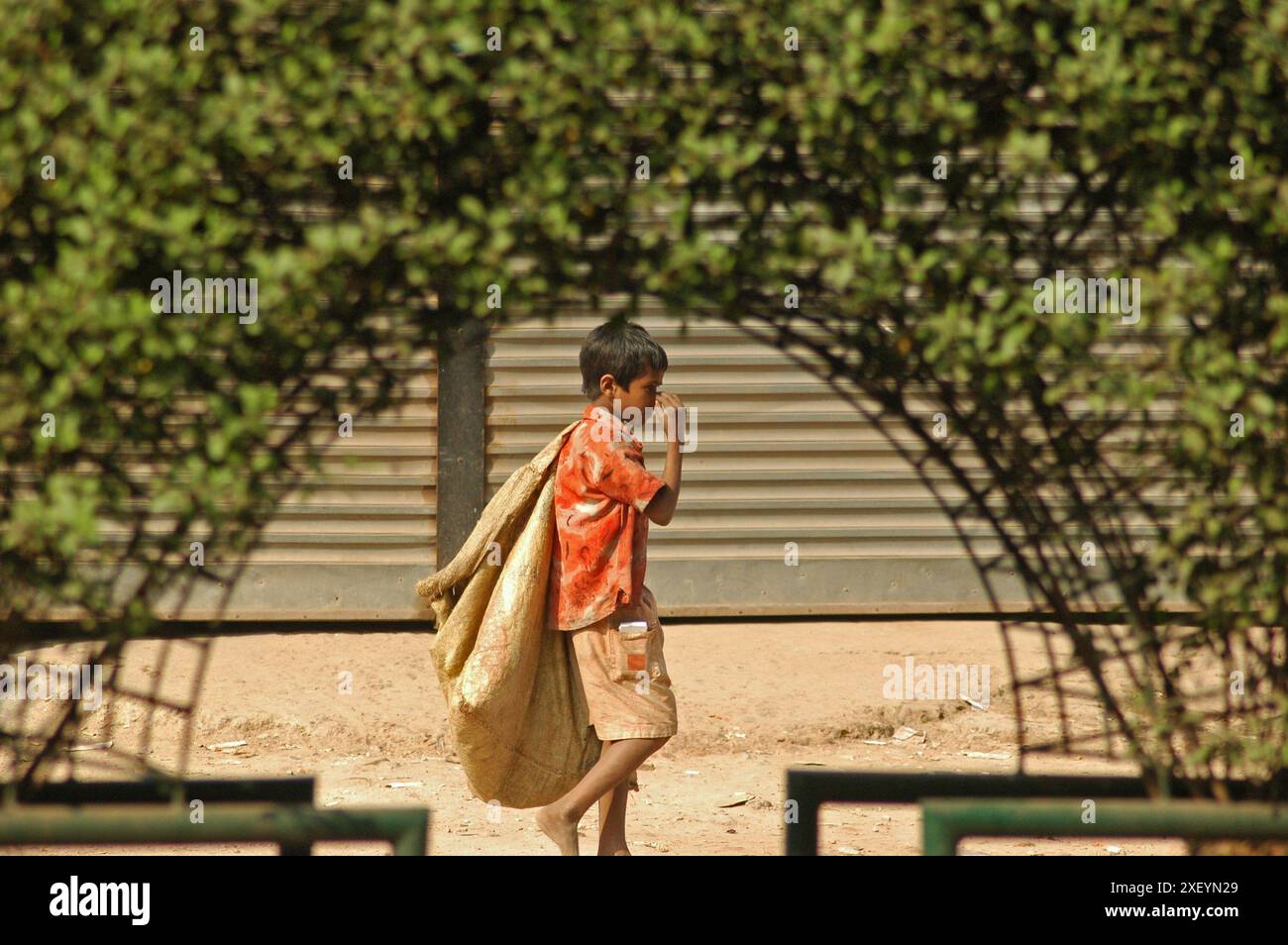 A street child make his way through a city street, Dhaka, Bangladesh ...