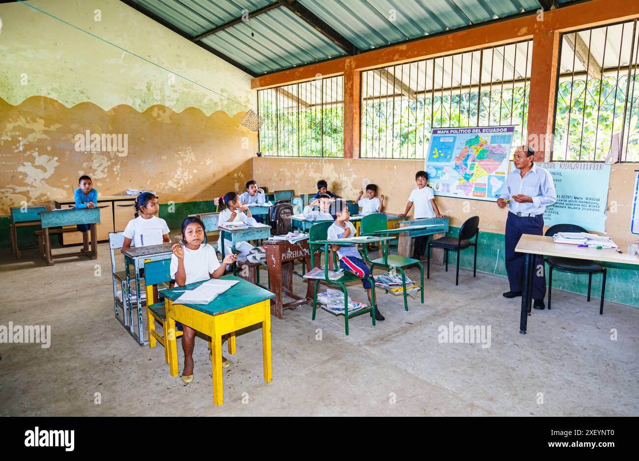 Teacher and local children learning in a school classroom in the Pilchi ...