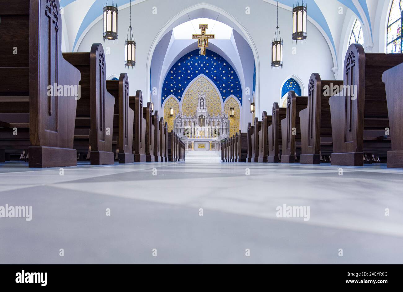 Low angle view of church aisle interior, Saint Clare of Assisi Catholic ...
