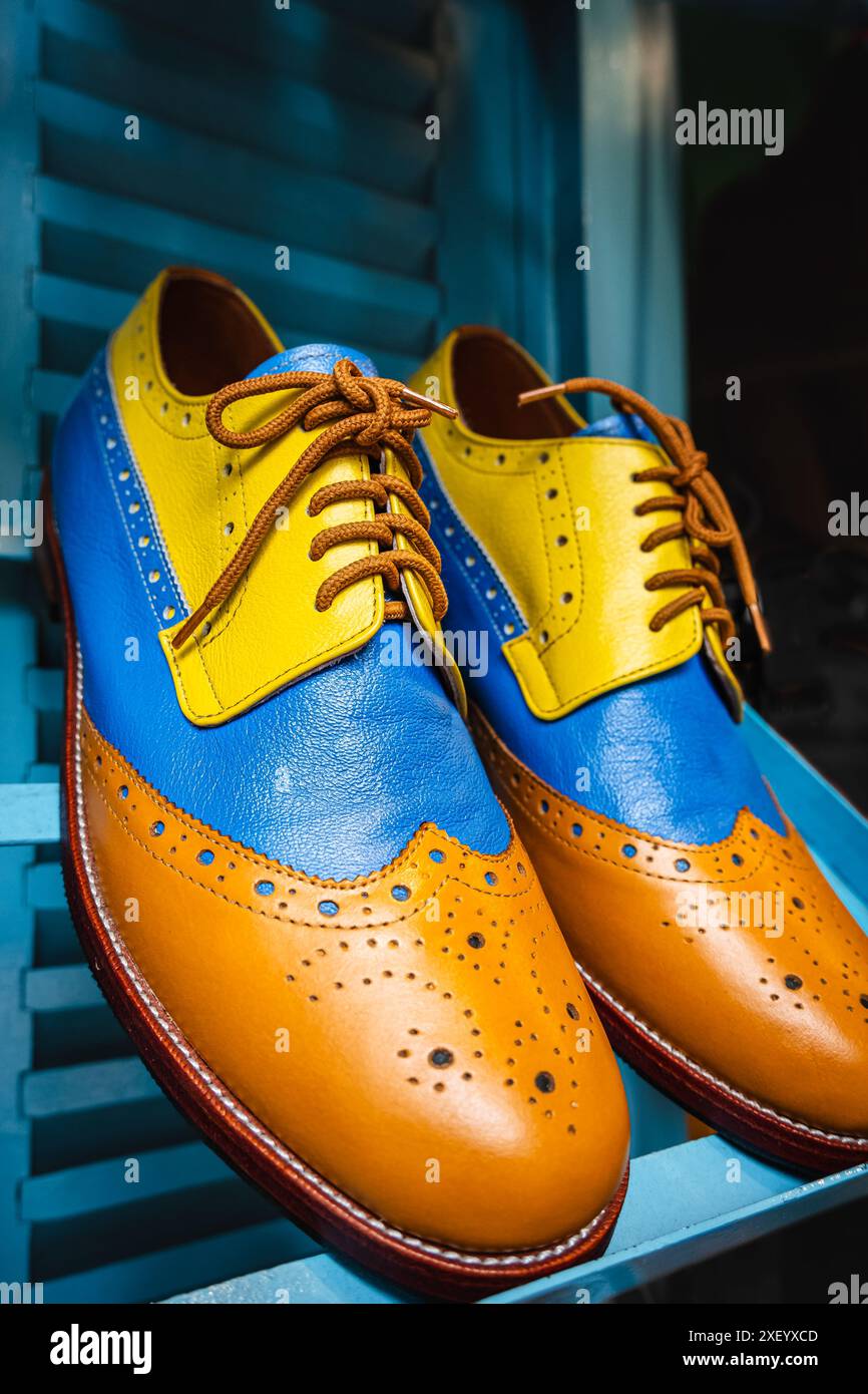 Colorful stylish leather dress shoes on a store shelf. Men fashion ...