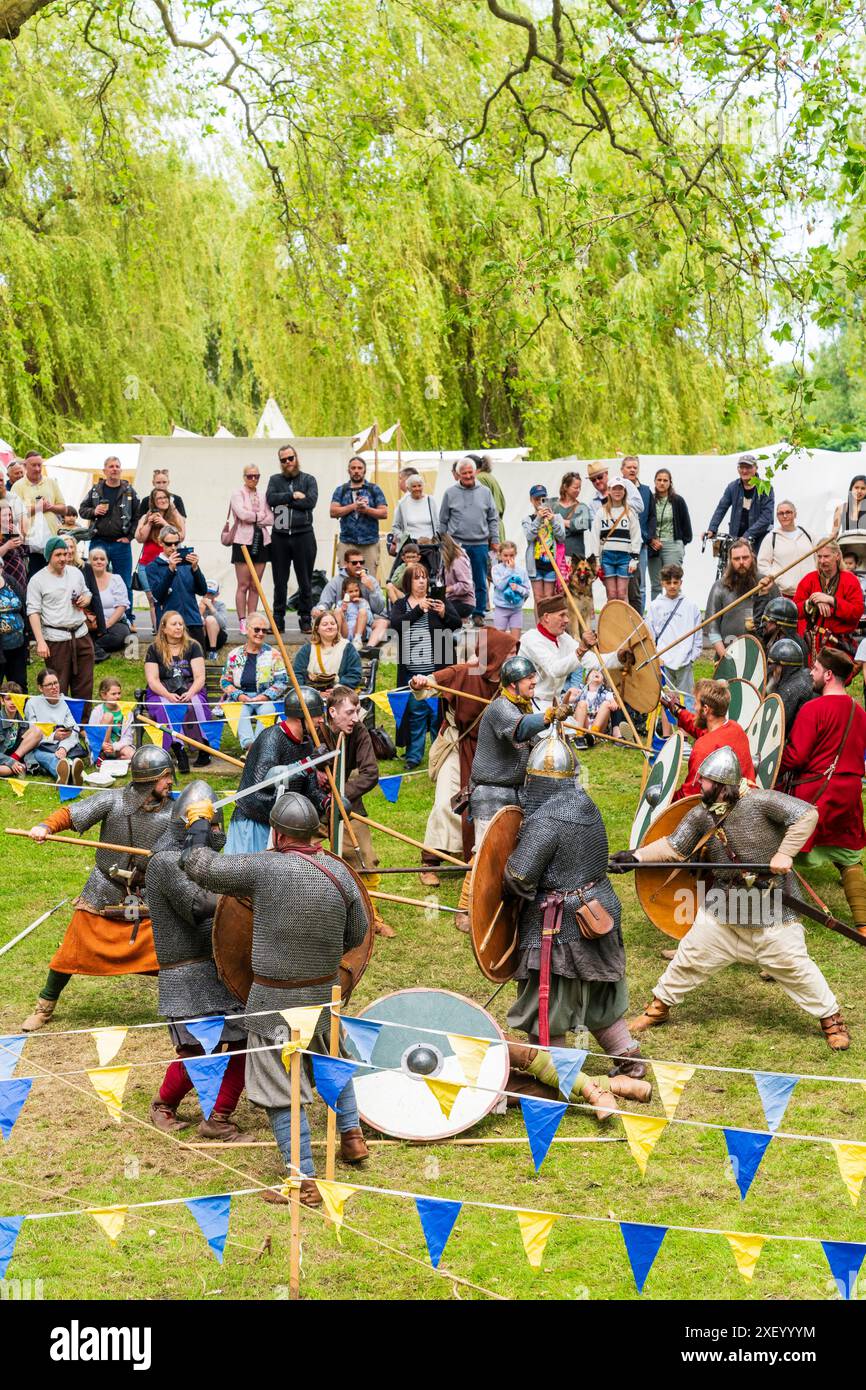 Mock battle with with two groups knights fighting each other in roped ...