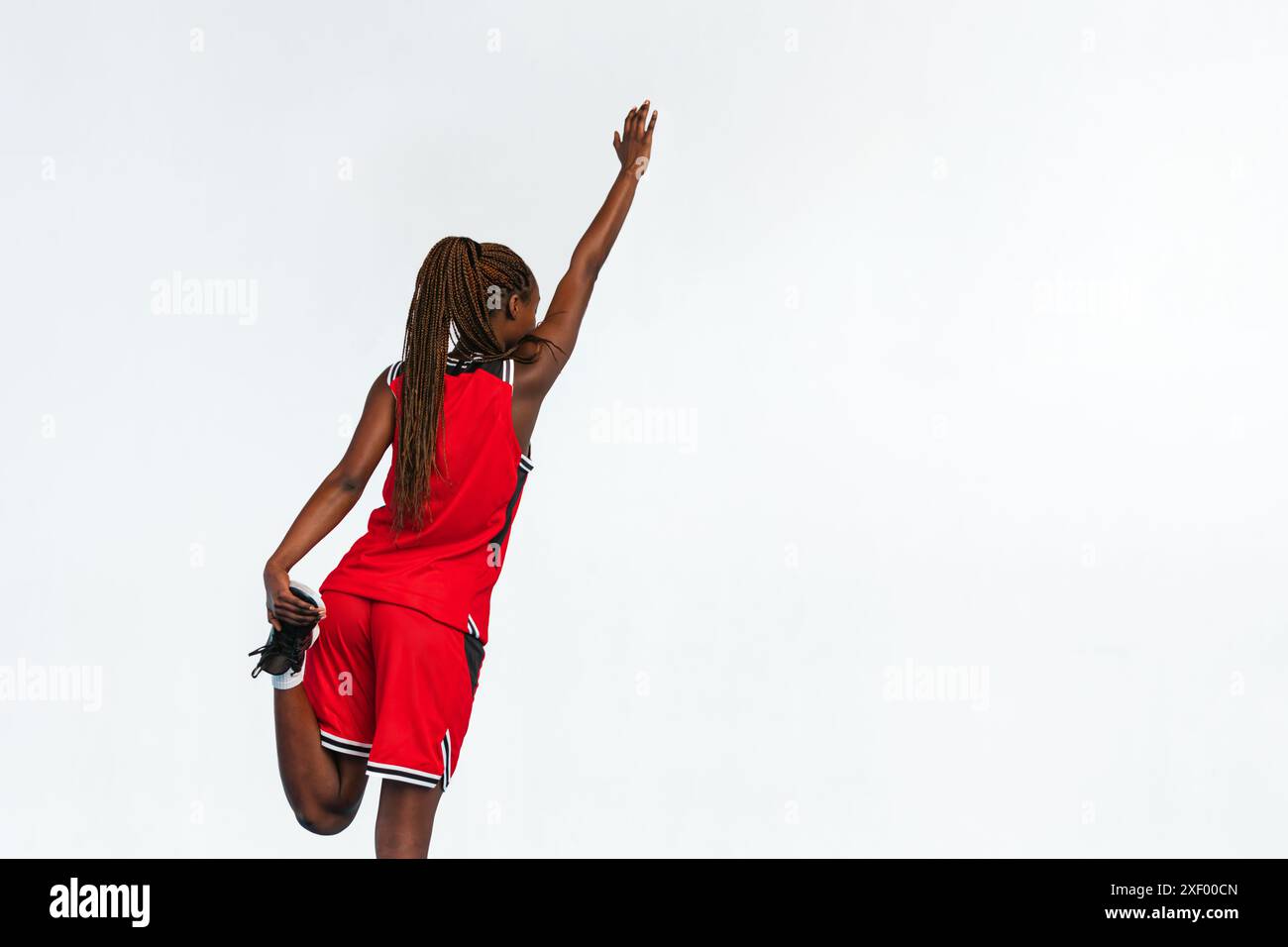 Horizontal photo a young female basketball player in a red jersey ...