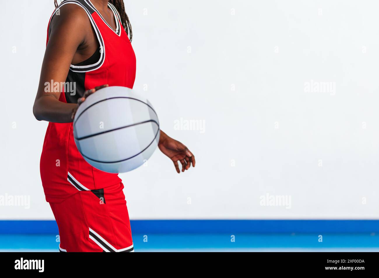 Horizontal photo close-up of a female basketball player in a red ...