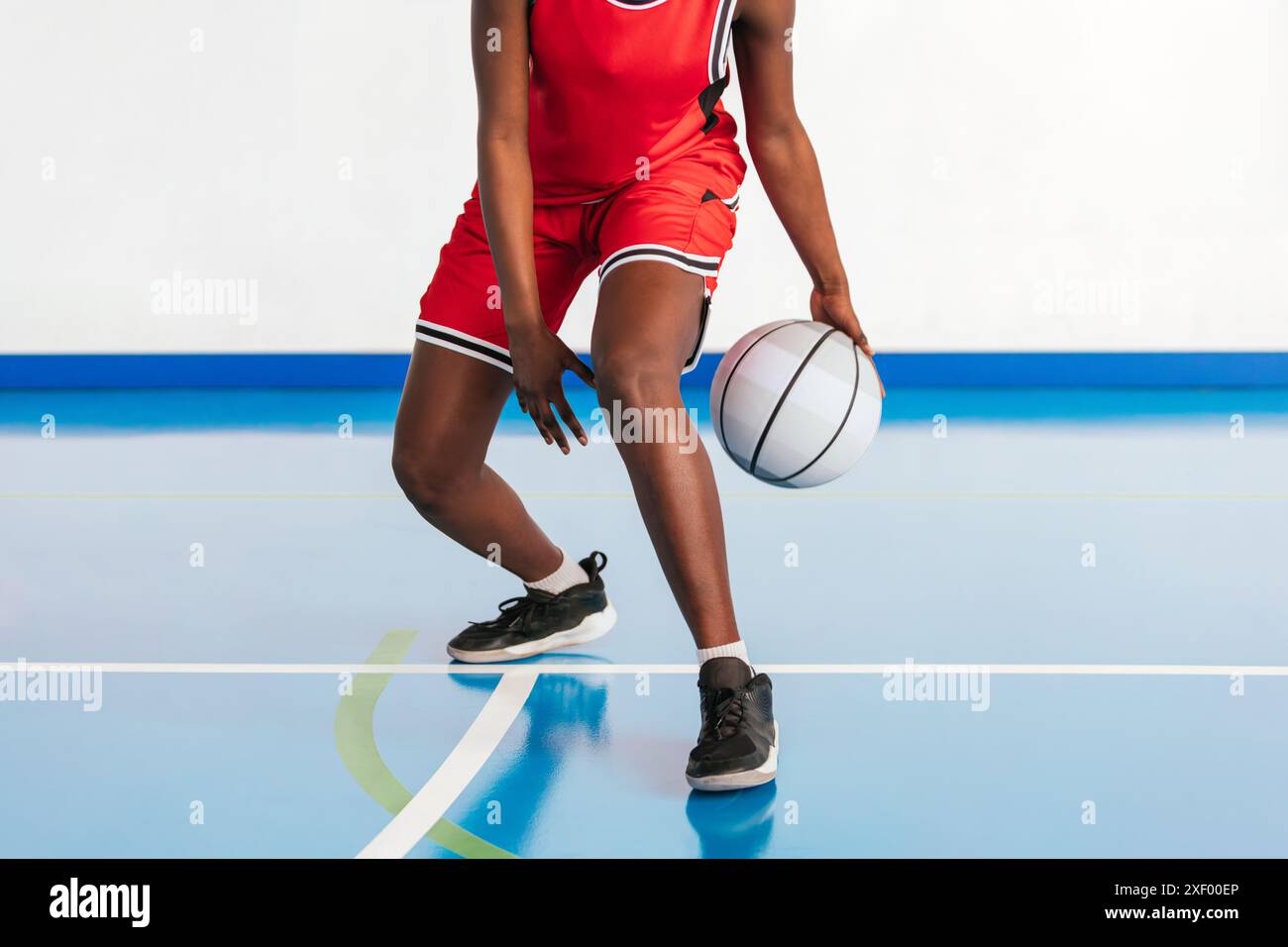 Horizontal photo close-up of a female basketball player in a red ...