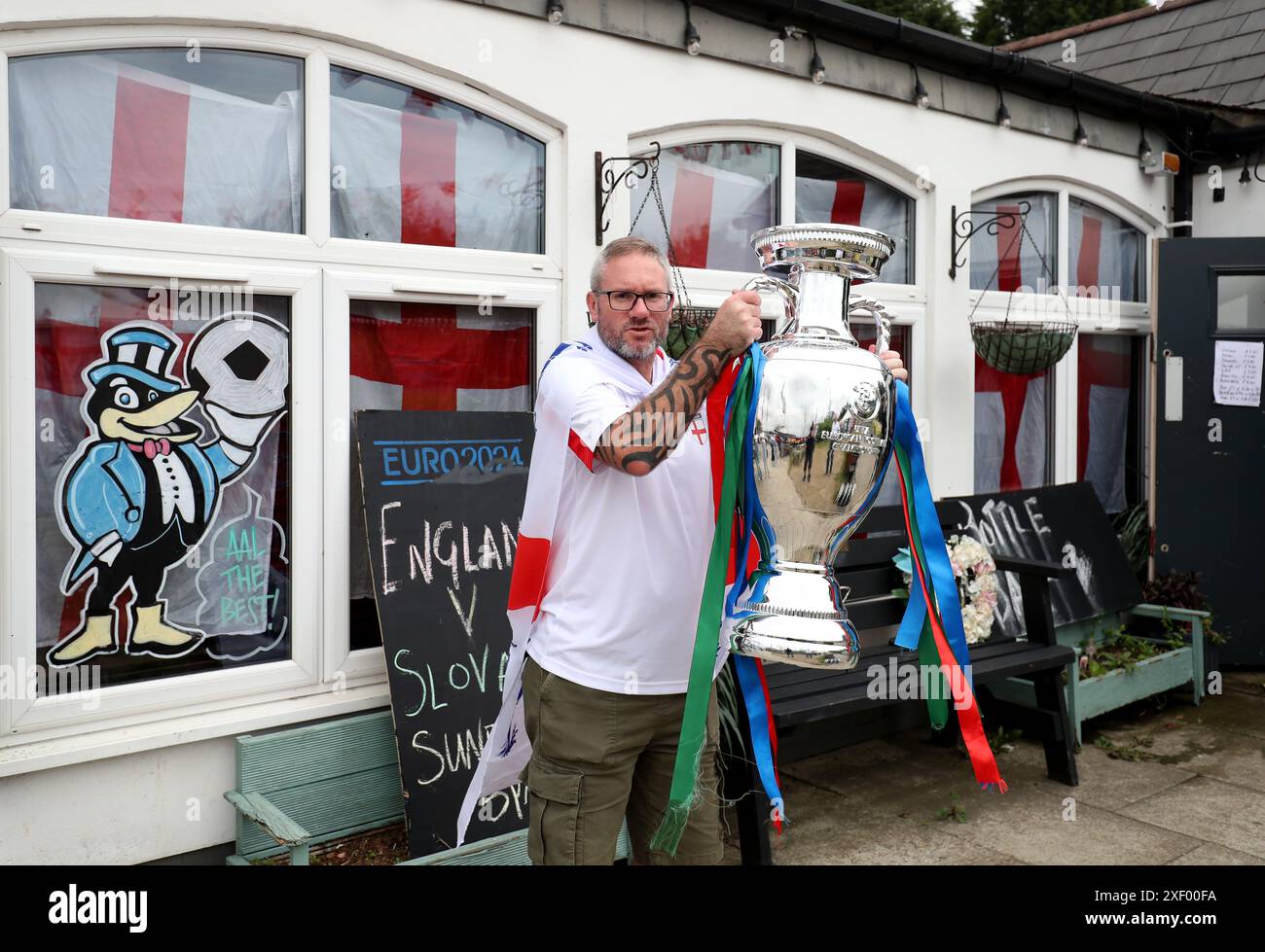 An England fan with a replica of the trophy at Dougie's Tavern in ...