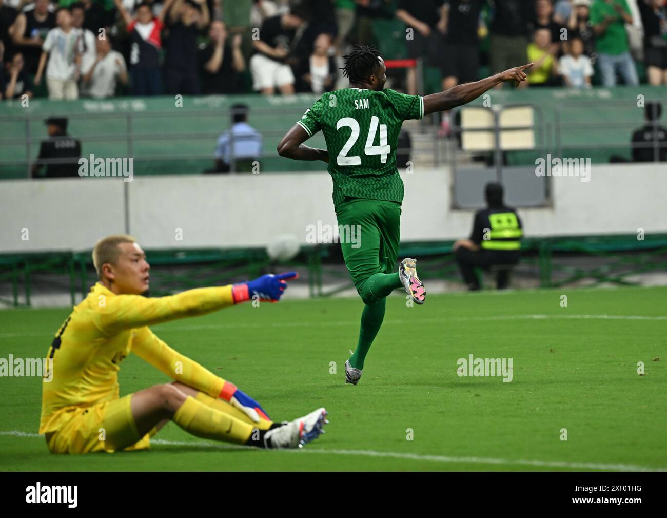 Beijing, China. 30th June, 2024. Samuel Adegbenro (R) of Beijing Guoan ...