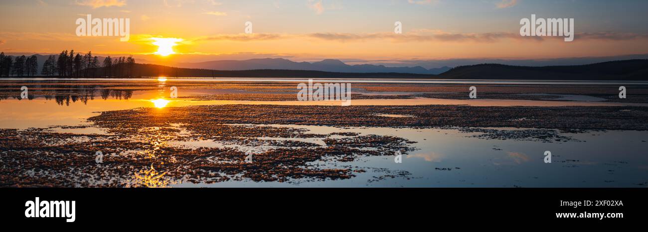 Ice floats on Lake Hovsgol and is colored by the evening sun. northern ...