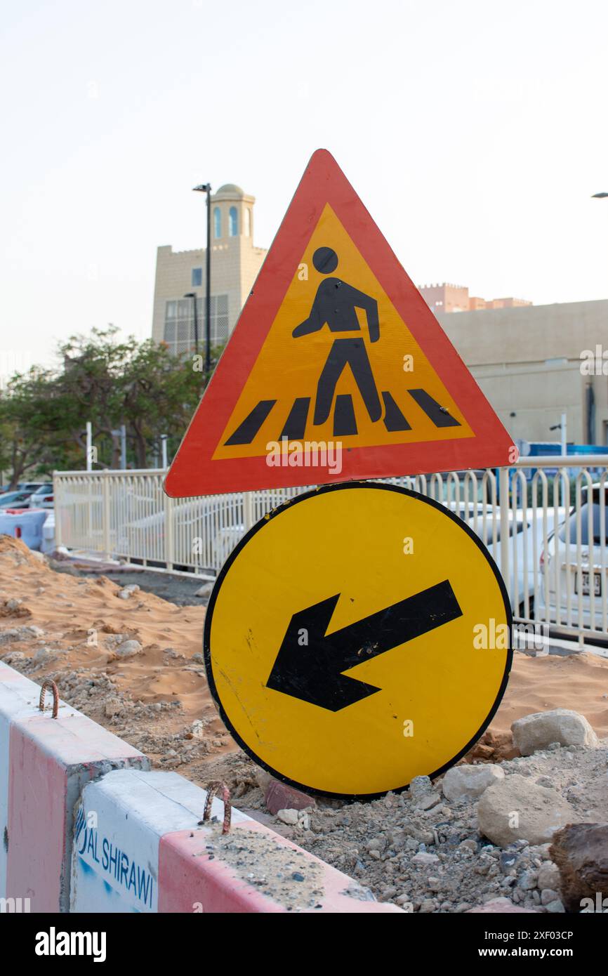 Pedestrian crossing and left arrow construction signs in Dubai City ...
