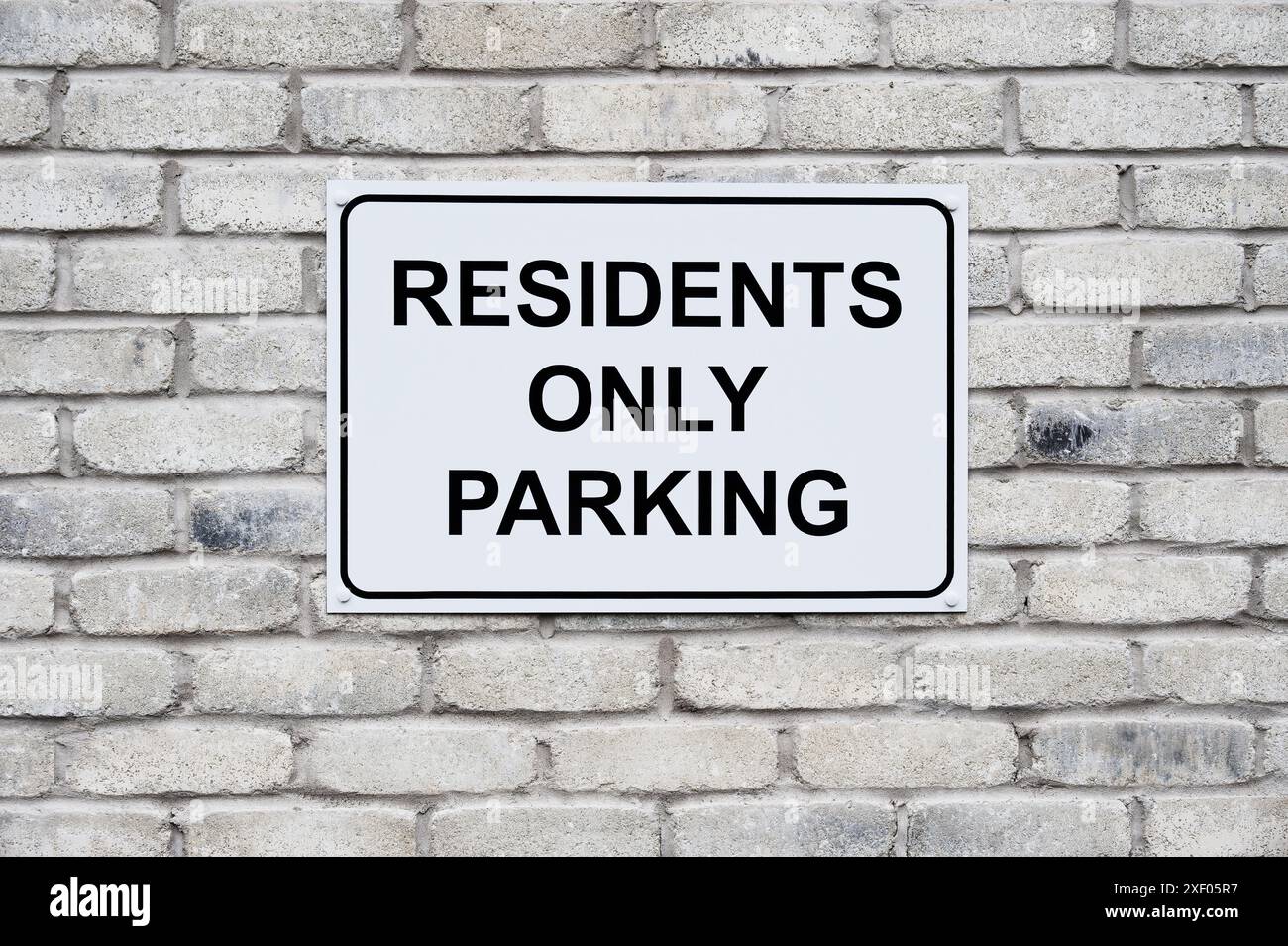 Residents only parking sign on wall at private housing development ...