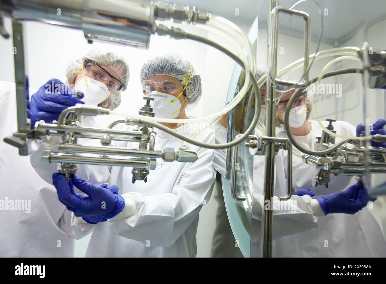 Technicians performing maintenance functions on a solid coating machine ...