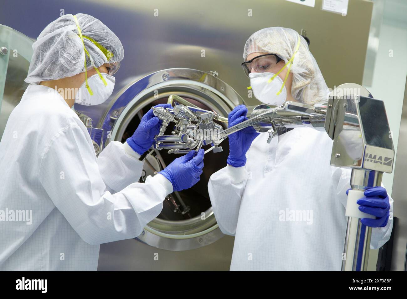 Technicians performing maintenance functions on a solid coating machine ...