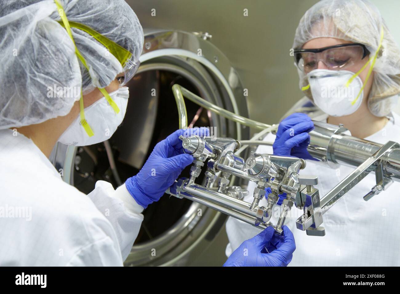 Technicians performing maintenance functions on a solid coating machine ...