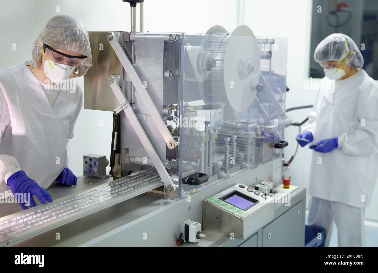 Technicians performing in-process control of tablets in a blister ...