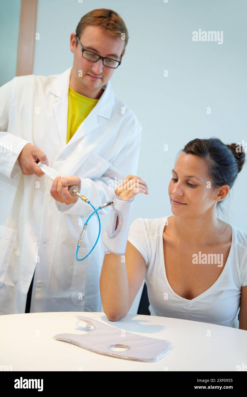 Researcher placing a patient splint prototype built with variable ...