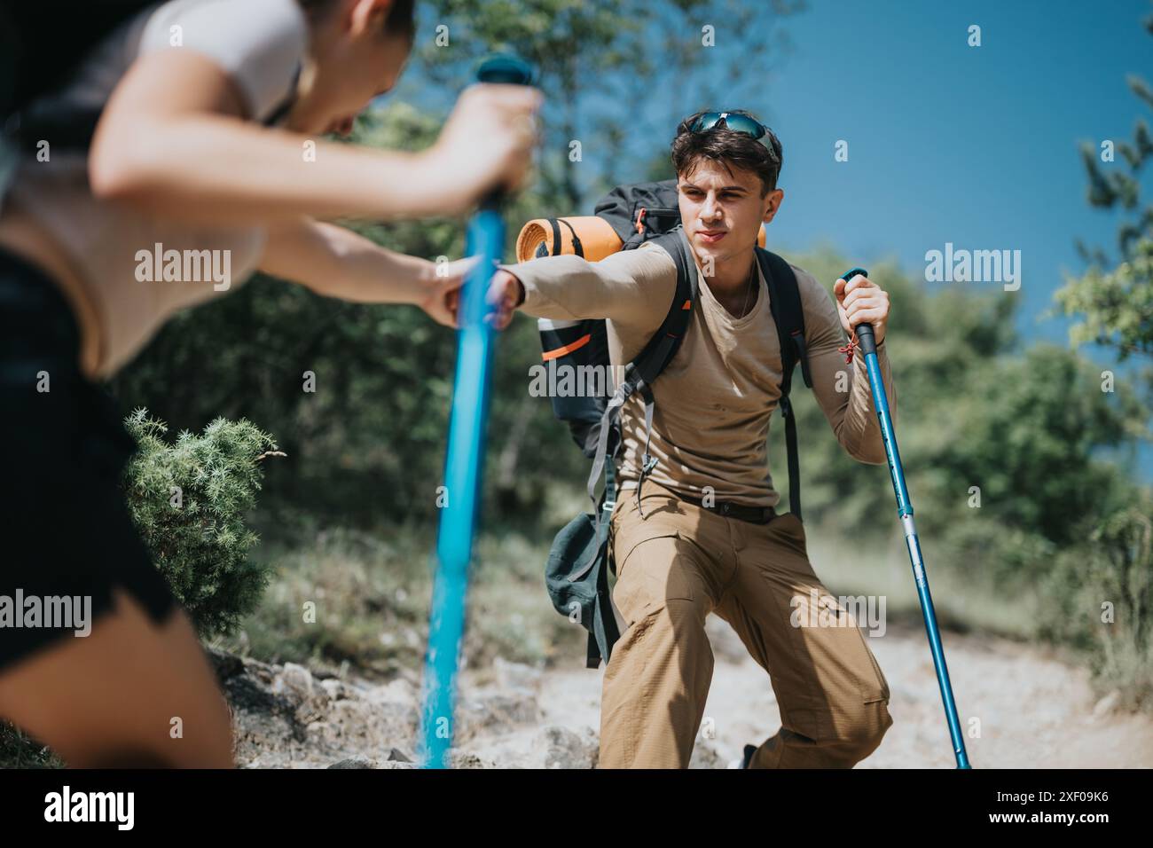 Hikers on a mountain trail, supporting each other through teamwork and ...