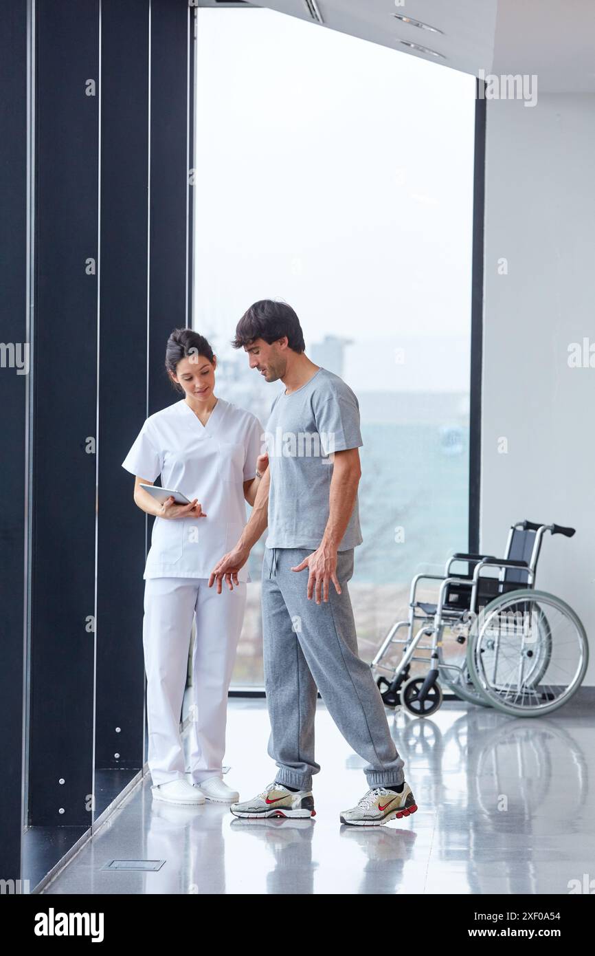 Physical therapist helping a patient to walk Stock Photo - Alamy