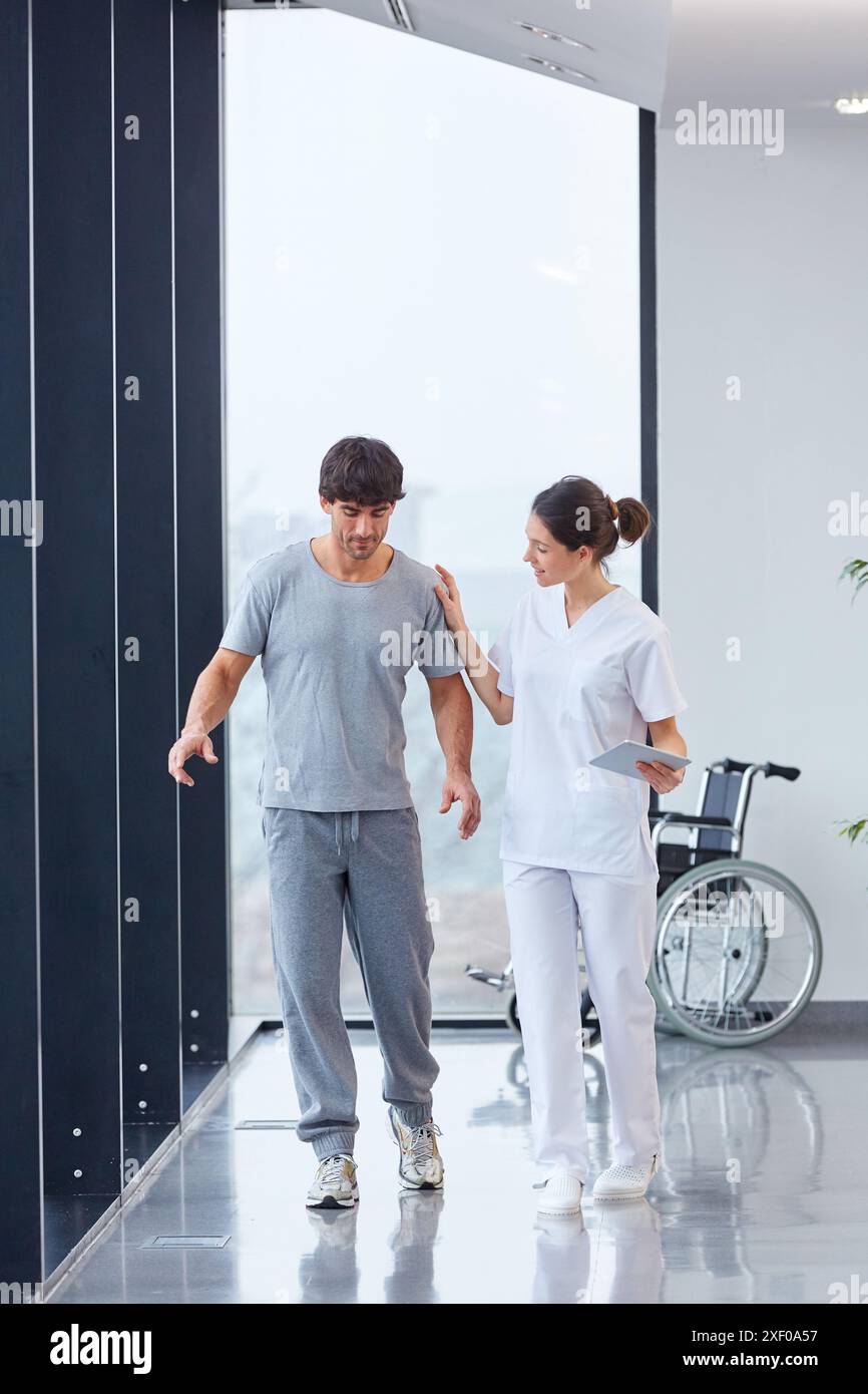 Physical therapist helping a patient to walk Stock Photo - Alamy