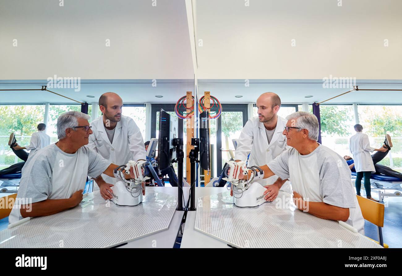 Therapist and patient with assistive robot for upper limb ...