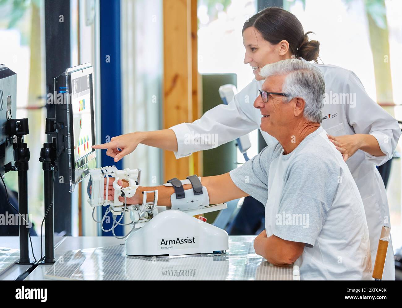 Therapist and patient with assistive robot for upper limb ...
