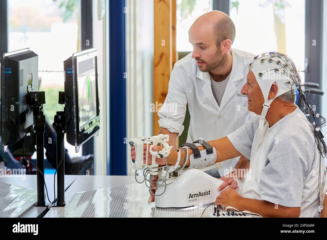 Investigator and patient with assistive robot for upper limb ...