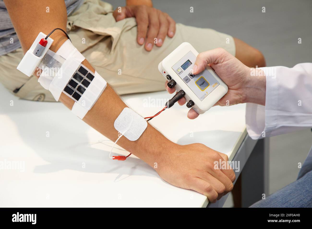 Researcher placing multipad electrodes in the control arm for the ...