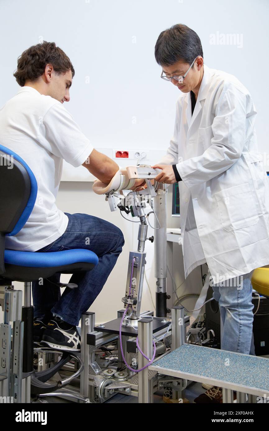 Researcher placing a patient clinical training device of the limb has ...