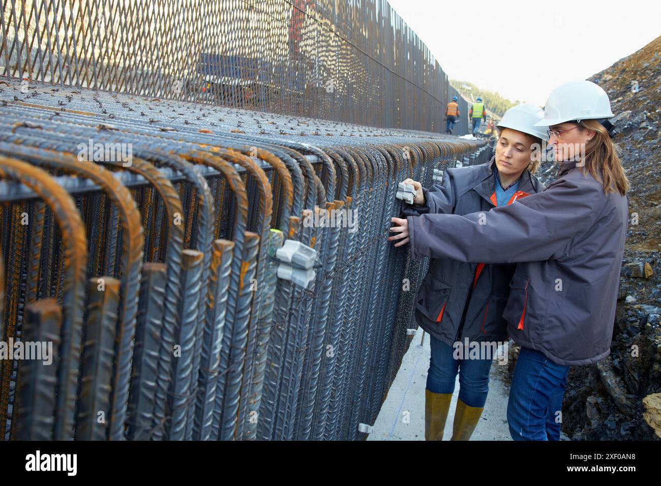 Architect overseeing the installation of rebar, reinforcing steel bars ...