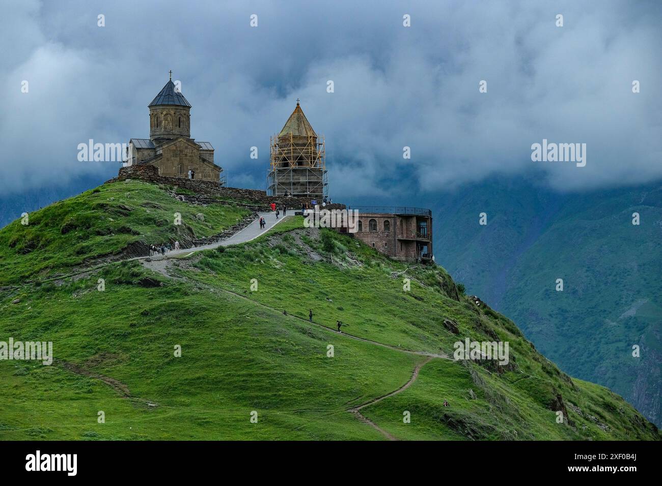 Stepantsminda, Georgia - June 30, 2024: People visiting the Gergeti ...
