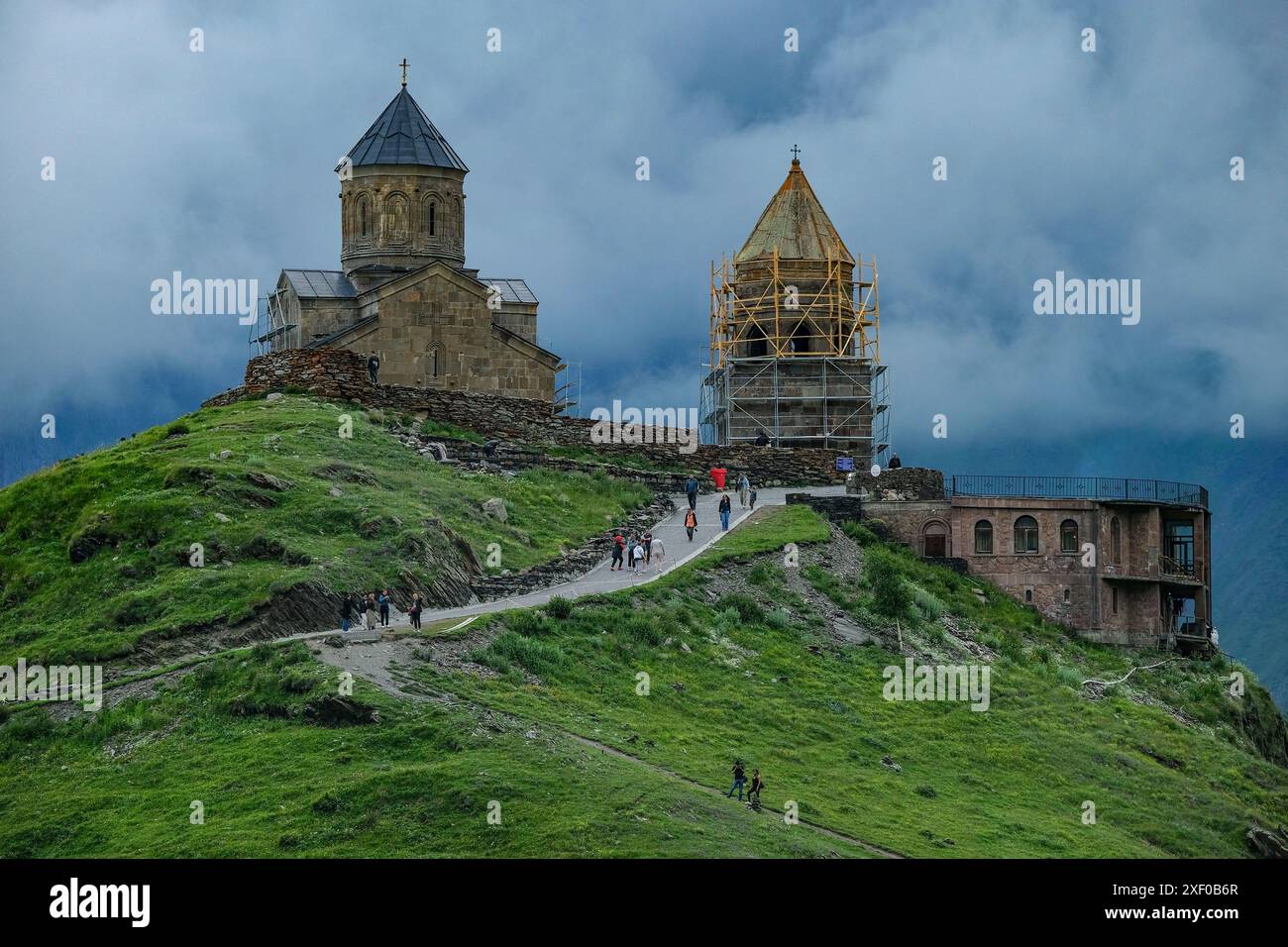 Stepantsminda, Georgia - June 30, 2024: People visiting the Gergeti ...