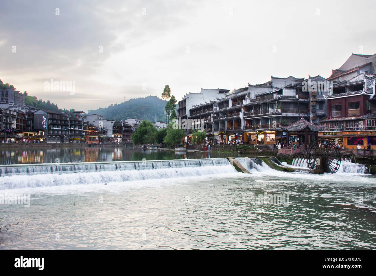Landscape tuojiang river with dike block stone weir and cityscape ...