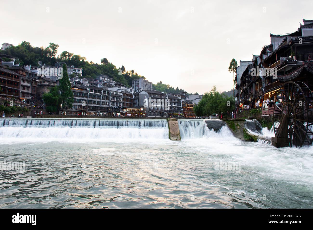 Landscape tuojiang river with dike block stone weir and cityscape ...