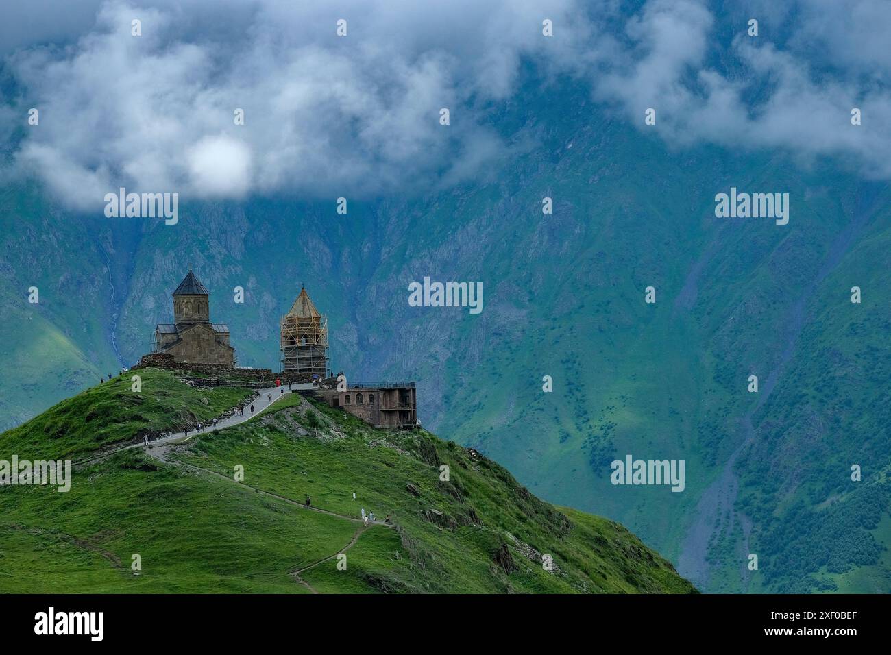 Stepantsminda, Georgia - June 30, 2024: People visiting the Gergeti ...