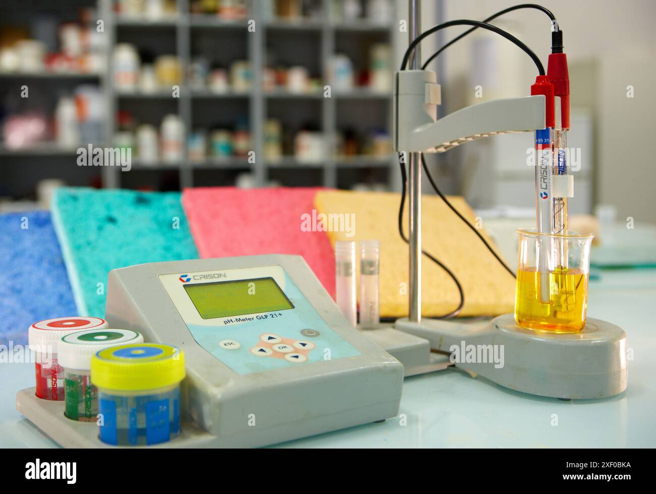Selective electrode pH meter and samples of coloured cement for study ...