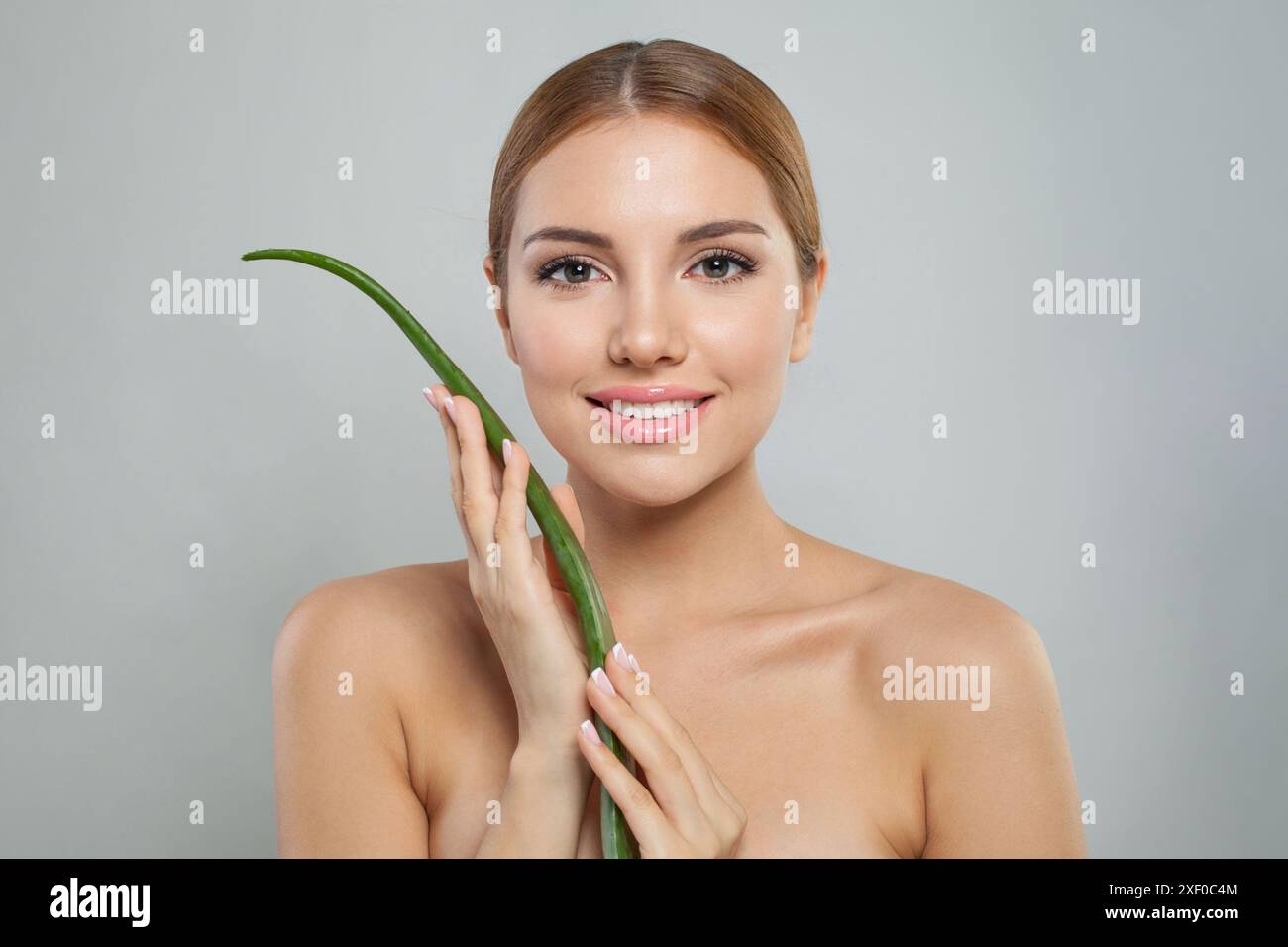 Portrait of beautiful woman with aloe vera on grey background Stock ...