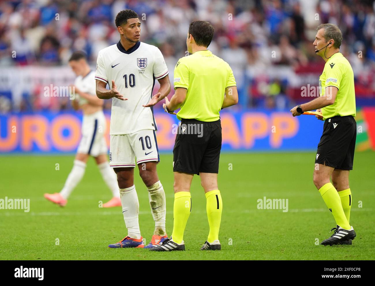 England's Jude Bellingham (left) speaks to match referee Umut Meler at ...