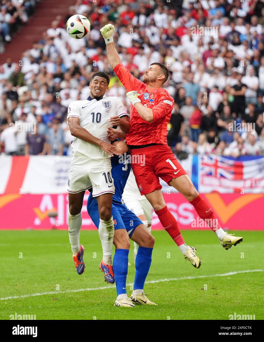England's Jude Bellingham (left) challenges Slovakia goalkeeper Martin ...