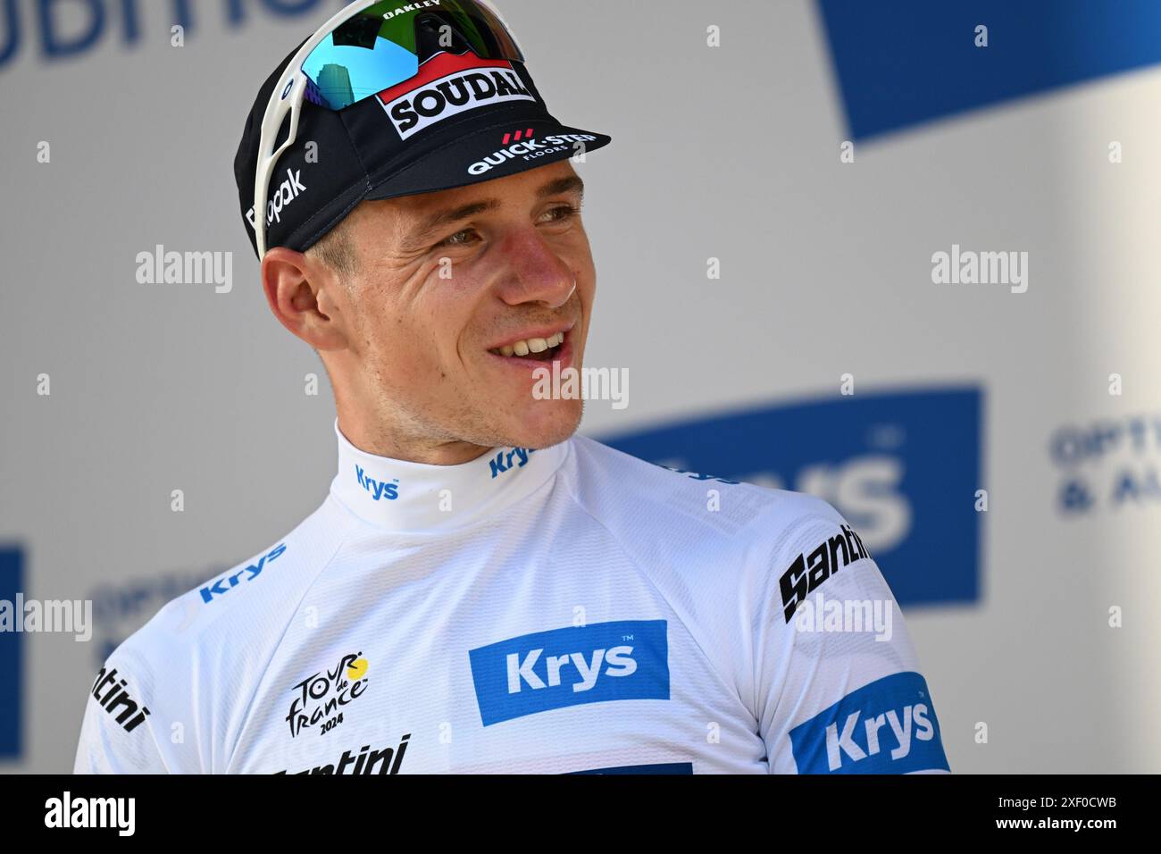 Remco Evenepoel smile portrait celebrating white jersey on the podium ...