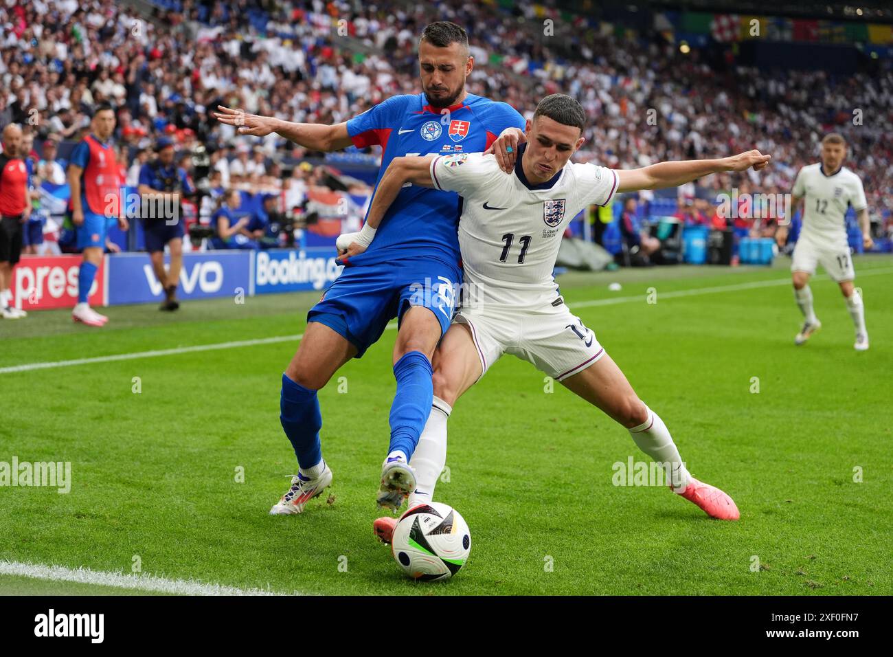 England's Phil Foden (right) and Slovakia's Peter Pekarik battle for ...
