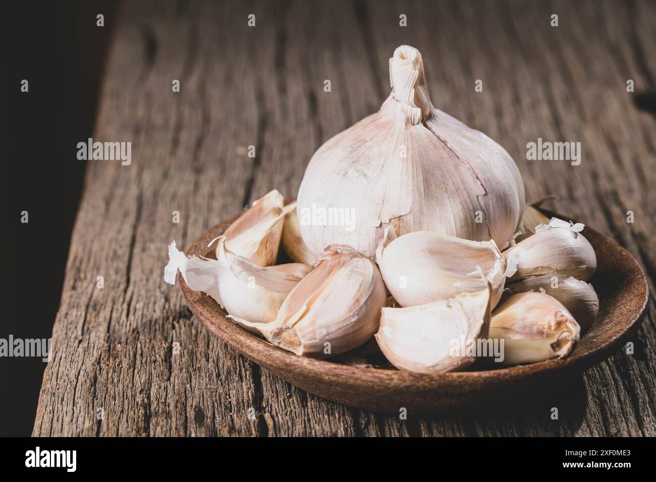 Garlic on a rustic wood background Stock Photo - Alamy