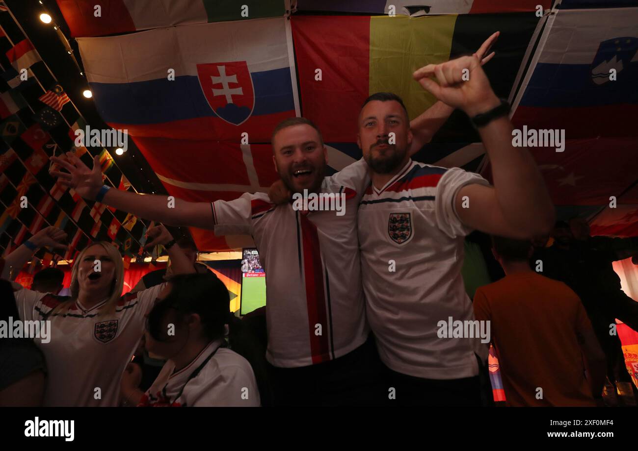 England fans celebrate after Jude Bellingham's goal at Dougie's Tavern ...