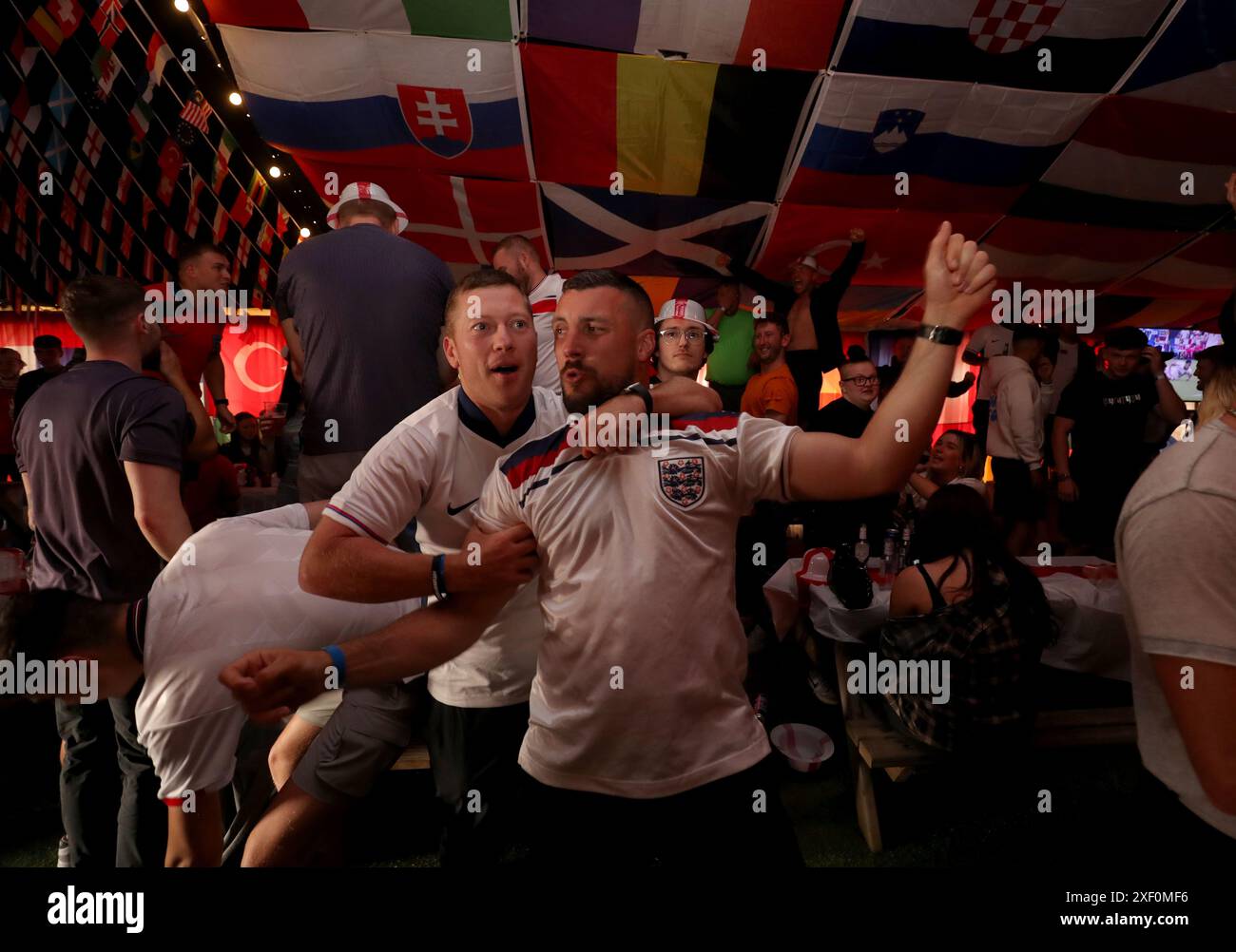 England fans celebrate after Jude Bellingham's goal at Dougie's Tavern ...